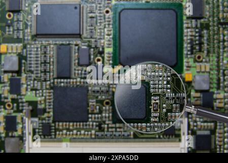 Detailed view of a computer motherboard with a magnifying glass ...