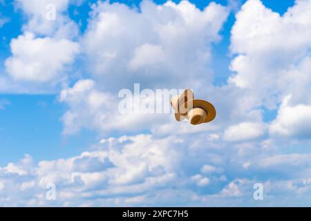 Straw hats flying in a blue sky Stock Photo - Alamy