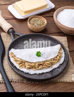 Traditional brazilian chicken stuffed tapioca on a pan with ingredients ...