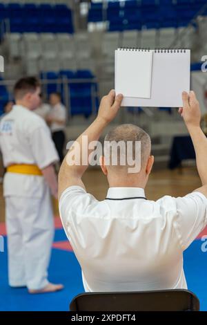 The karate referee shows marks during martial art competition. Copy ...