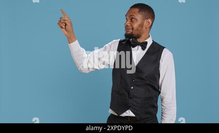 Doorkeeper bellhop pointing at something to left or right sides ...