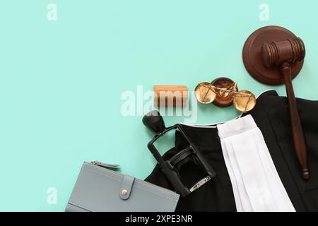 Composition with judge's gown, gavel, justice scales and wallet on blue ...
