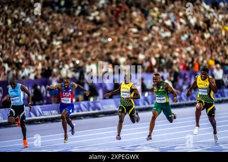 United States' Noah Lyles, right, crosses the finish line in first ...