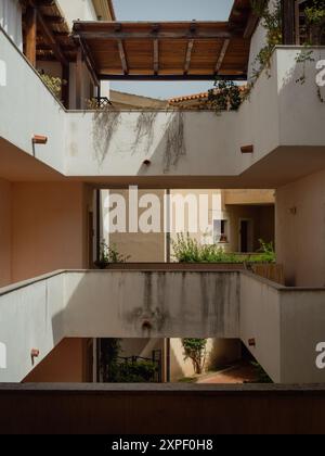 Vertical view of a cozy balcony corridor with white curtains and doors ...