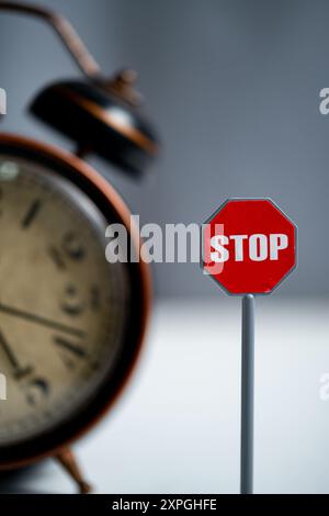 Stop sign and alarm clock on blue background. Stop time concept Stock ...