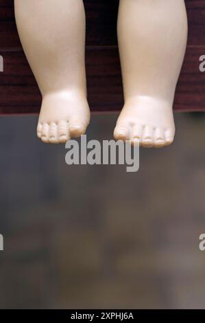 Plastic doll legs in toy shoes on a white background. educational games ...