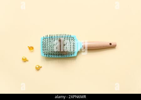 Brush, capsules and clump of hair on beige background. Hair loss ...