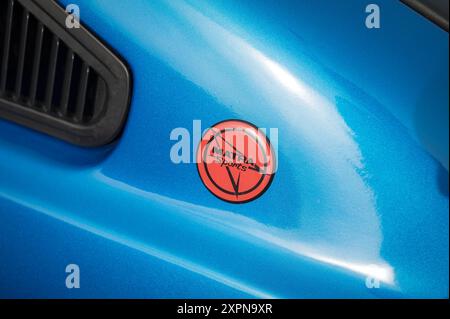 Detail of the Matra emblem on a blue Matra Murena. It is a circular red ...