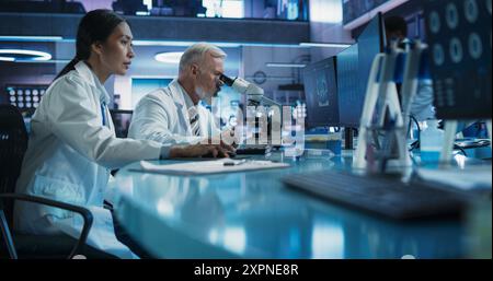 Female Asian Neurologist Using Desktop Computer With Human Brain MRI ...