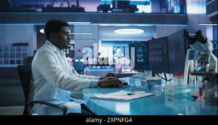 Black Male Neuroscientist Using Desktop Computer To Analyze MRI Scans ...