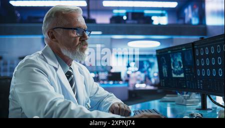 Senior Male Neuroscientist Using Desktop Computer To Analyze MRI Scans ...