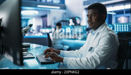 Black Male Neuroscientist Using Desktop Computer To Analyze MRI Scans ...