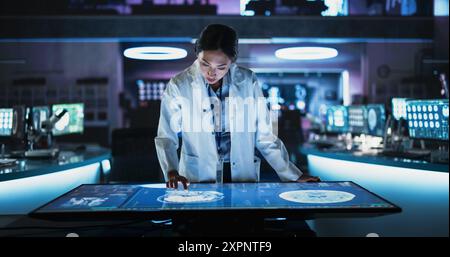 Female Asian Neuroscinetist Using Interactive Touch Screen Table With ...