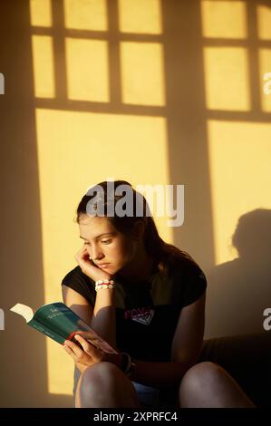 16 years old teenager reading a book Stock Photo - Alamy