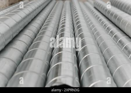Ventilation duct pipes made of rolled steel in a warehouse, storage at ...