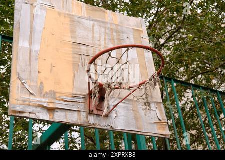 Abandoned, damaged and unused basketball backboard. Basket with torn ...