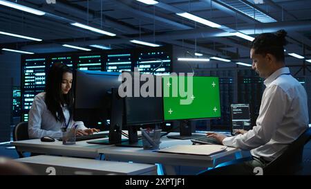 Programmer overseeing data center using isolated screen computer ...