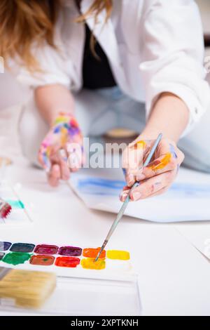 Artists hands paint close-up blue background drawing hobby Stock Photo ...