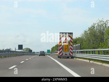 road sign indicating the narrowing of the lane. road sign with an arrow ...