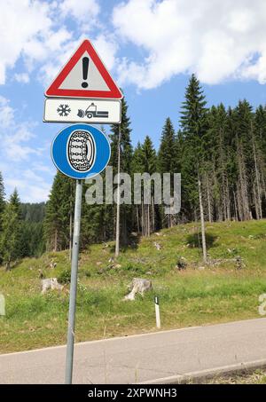 Road sign indicating the mandatory use of snow chains and snowplow ...