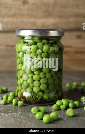 Marinated green peas in glass jar. On a rustic background Stock Photo ...