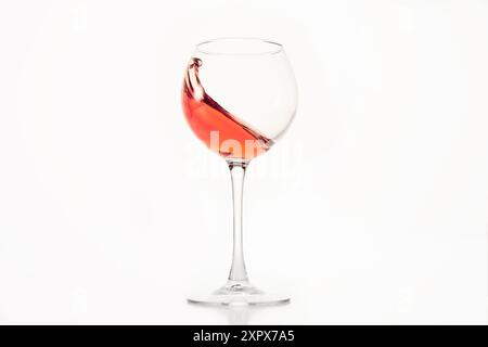 Diagonal wave of rose wine, alcohol is in glass on white isolated Stock ...