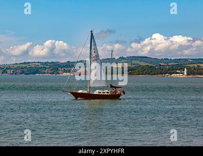 A Motor yacht sailing down Exmouth Beach, in the estuary of the River ...