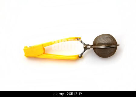 Mesh Snap Ball Tea Strainer with Yellow Plastic Handle Stock Photo - Alamy