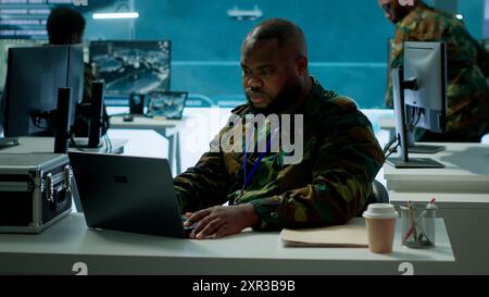 Intelligence agents in modern operations center managing surveillance ...