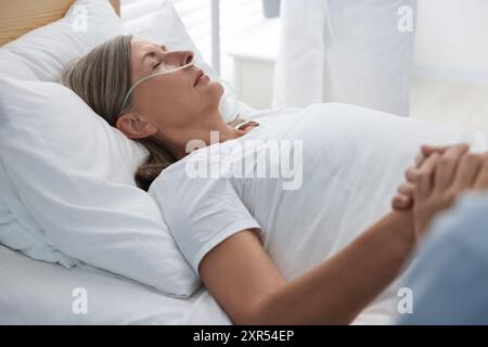 Coma patient. Man near his unconscious wife in hospital Stock Photo - Alamy