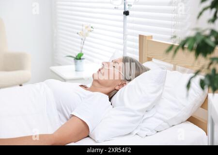 Coma patient. Mature woman sleeping in hospital bed Stock Photo - Alamy