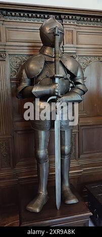 Medieval knight in full armor with a weightlifting barbell over a ...