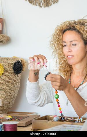 Woman making jewelry at home Stock Photo - Alamy
