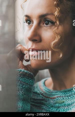 One confident lady contemplate outside the window at home with dreaming ...