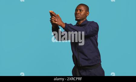 Security guard doing pretending to shoot gun hand gesture while being ...