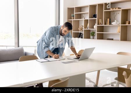 Handsome student working on laptop in bar Stock Photo - Alamy