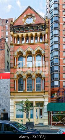 storefront in brick building near crossroad in downtown of new york ...