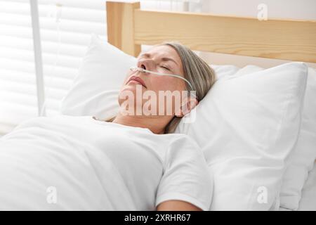 Coma patient. Mature woman sleeping in hospital bed Stock Photo - Alamy