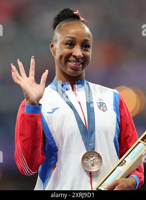 Bronze medalist Jasmine Camacho-Quinn, of Puerto Rico, embraces Cyréna ...