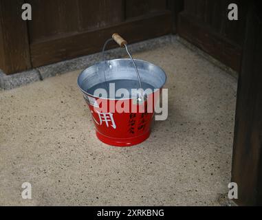 Traditional Japanese red galvanized iron fire prevention bucket in Nara ...