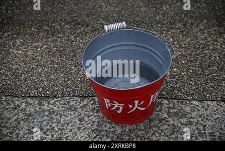 Traditional Japanese red galvanized iron fire prevention bucket in Nara ...
