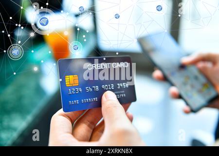 Using a credit card and phone to make online purchases in an online ...