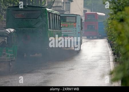 A public bus exhaust black smoke on a road at YiWu Stock Photo - Alamy