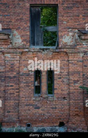 Vertical, narrow windows of a brick stable. 19th century building Stock ...