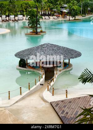 A traditional thatched hut is located within a swimming pool Stock ...