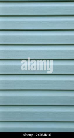 Close-up of vertical trim design on sage green wall paneling, styled in ...