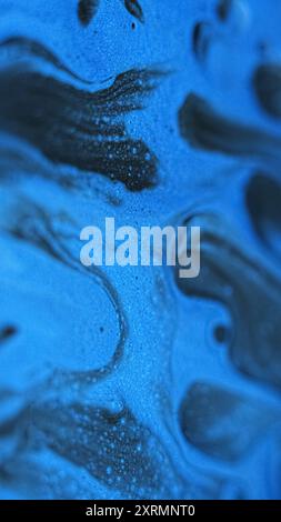 Glowing liquid. Ink glitter. Defocused pink silver black color spill ...