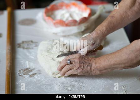 old woman hands kneading bread dough in a plastic bowl Stock Photo - Alamy