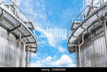 An industrial facility with large metal pipes, valves and cylindrical ...