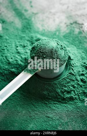Green spirulina powder in a plastic measuring cup, top view Stock Photo ...